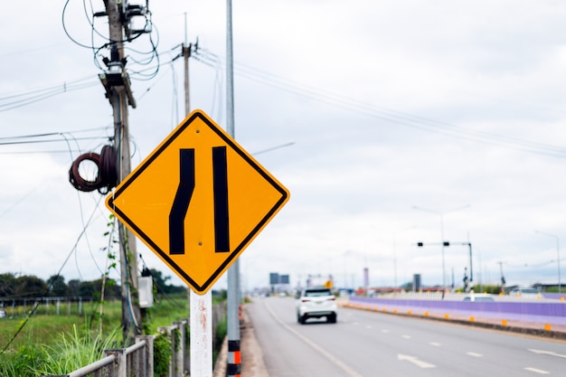 Traffic sign, road narrows on left Photo | Premium Download Traffic sign, road narrows on left Photo | Premium Download