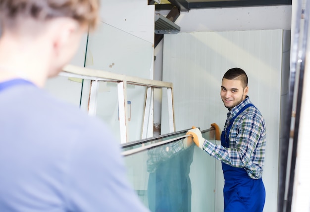 Premium Photo Two Careful Workmen Working With Glass