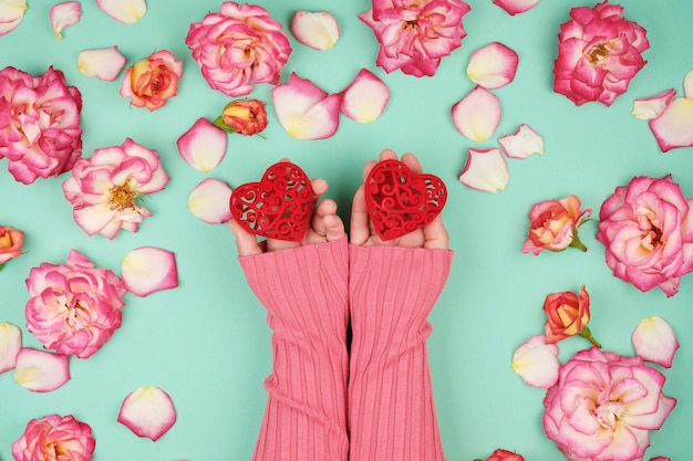 Premium Photo | Two female hands hold red hearts Premium Photo | Two female hands hold red hearts
