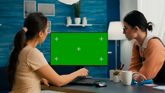 Premium Photo | Two friends sitting in front of mock up computer green ... Premium Photo | Two friends sitting in front of mock up computer green ...