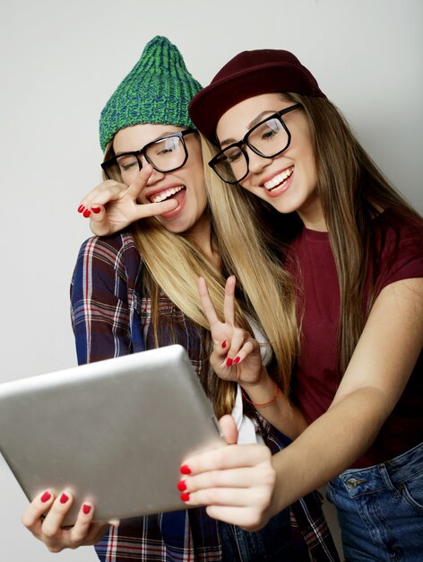 Premium Photo Two Hipster Girls Friends Taking Selfie With Digital Tablet