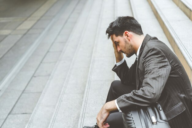 Premium Photo | Unemployed businessman stress sitting on stair Premium Photo | Unemployed businessman stress sitting on stair
