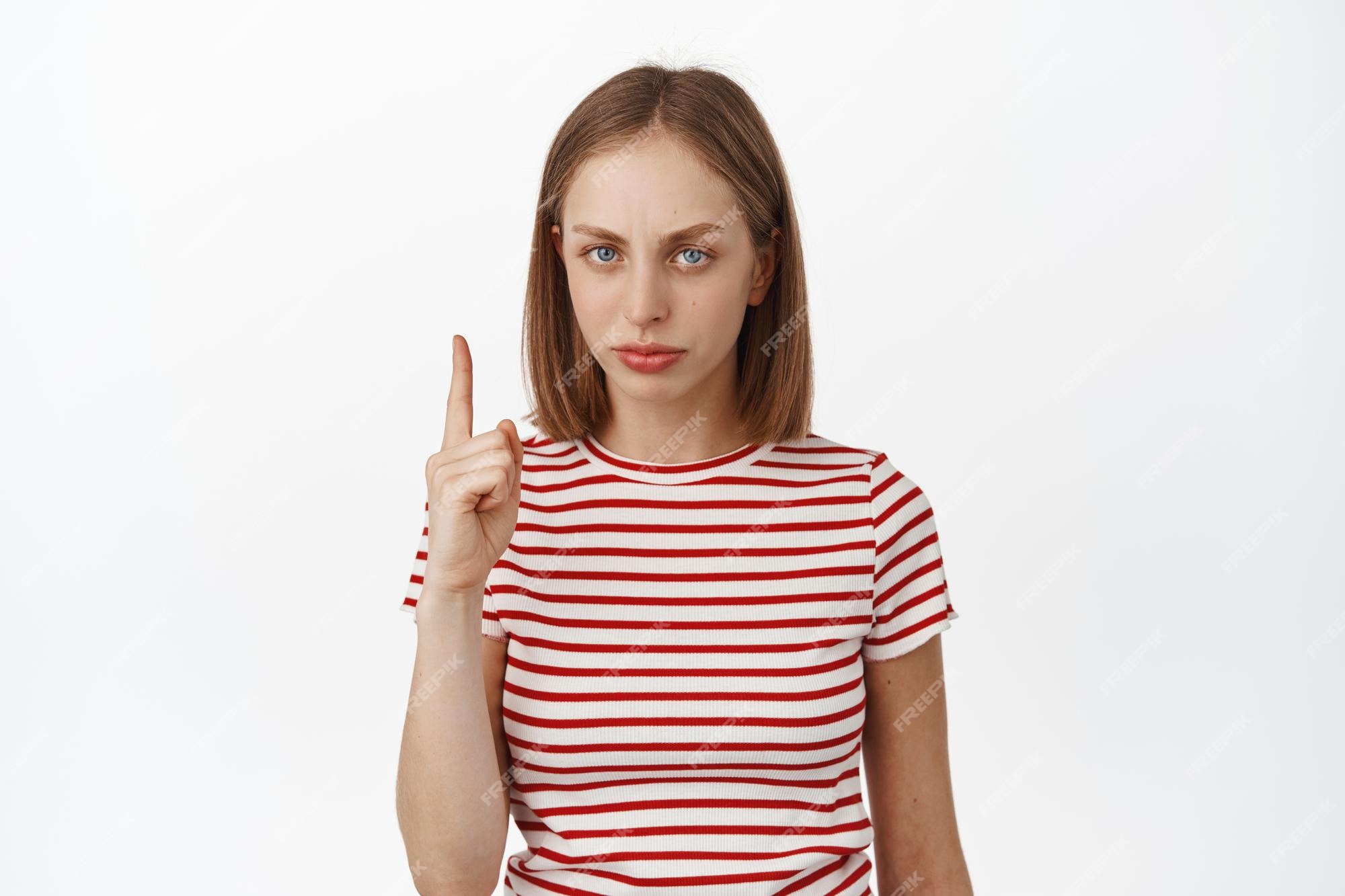 Free Photo Upset Blond Girl Pointing Finger Up Frowning Displeased