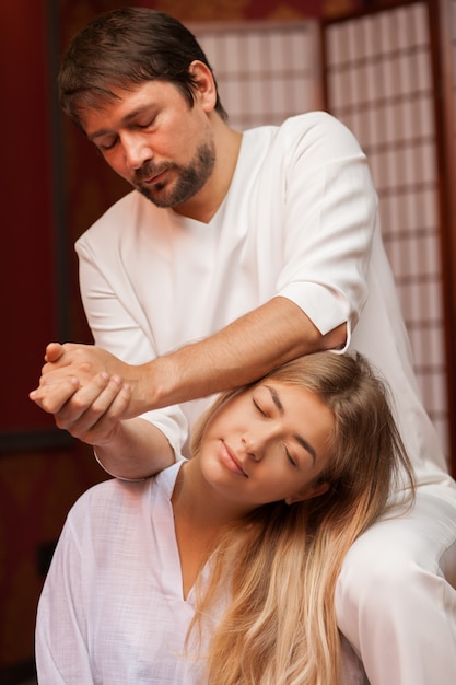 Premium Photo Vertical Shot Of A Mature Male Thai Masseur Stretching