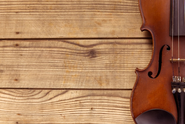 Premium Photo | Violin lies on a wooden table background Premium Photo | Violin lies on a wooden table background