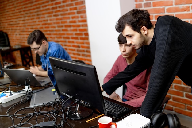 Premium Photo | Website design. programmers working in a software develop company office ...