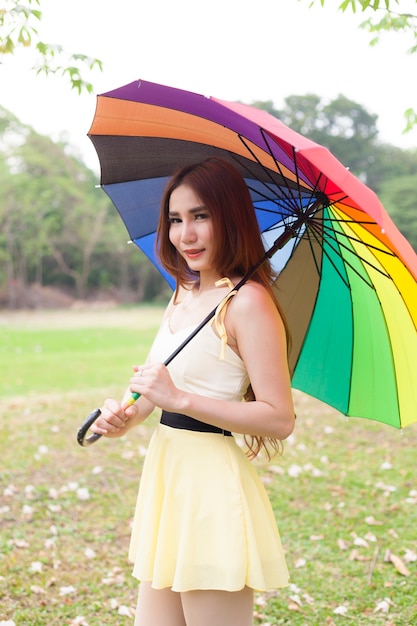 Premium Photo | Woman holding multicolored umbrella Premium Photo | Woman holding multicolored umbrella