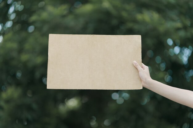 Premium Photo Womans Hands Holding A Blank Placard To Put The Text