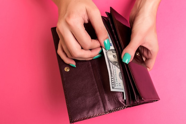 Premium Photo | Womans hand removing money from wallet studio shot Premium Photo | Womans hand removing money from wallet studio shot