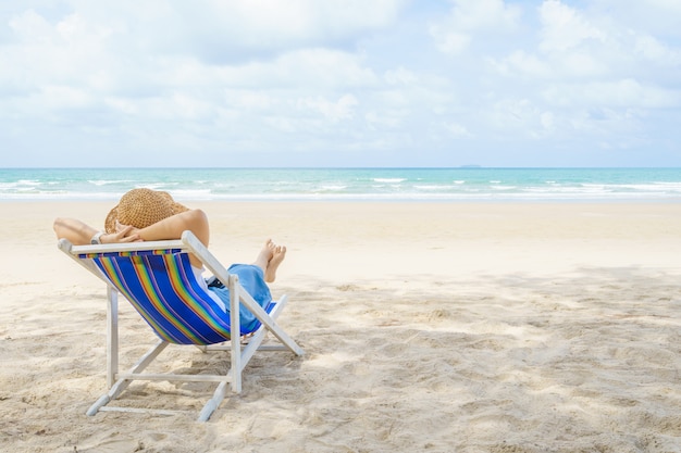 Premium Photo Young Beautiful Asian Woman Relax In The Sun On Chairs
