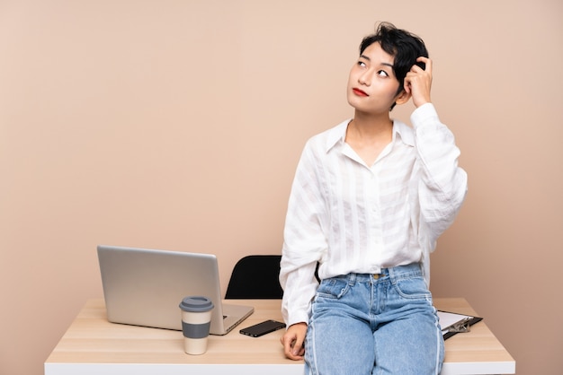 Premium Photo | Young business asian woman in her workplace having ... Premium Photo | Young business asian woman in her workplace having ...
