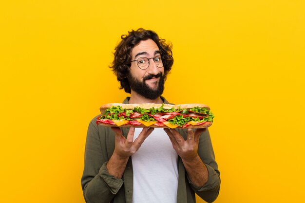 Premium Photo | Young crazy bearded man with a giant sandwich. Premium Photo | Young crazy bearded man with a giant sandwich.