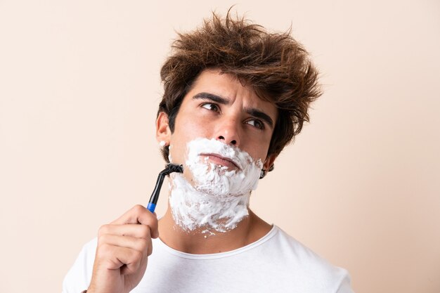 Premium Photo Young Handsome Man Shaving His Beard