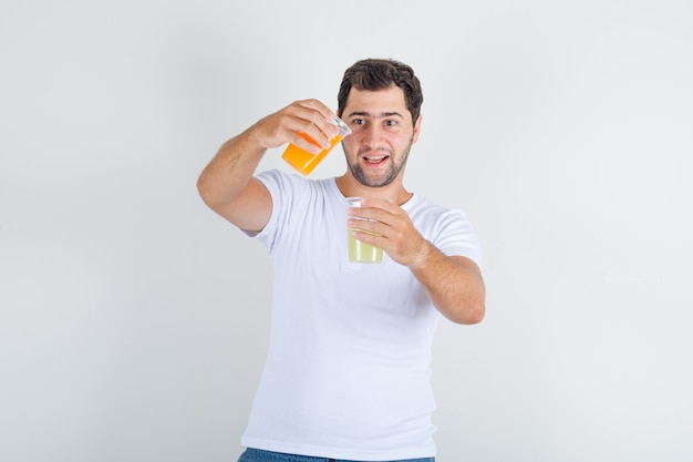 Free Photo | Young male mixing different juice by pouring in white t ... Free Photo | Young male mixing different juice by pouring in white t ...