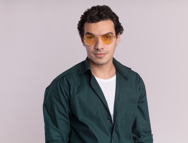 Free Photo Young Man In Green Shirt Wearing Glasses Looking At Front