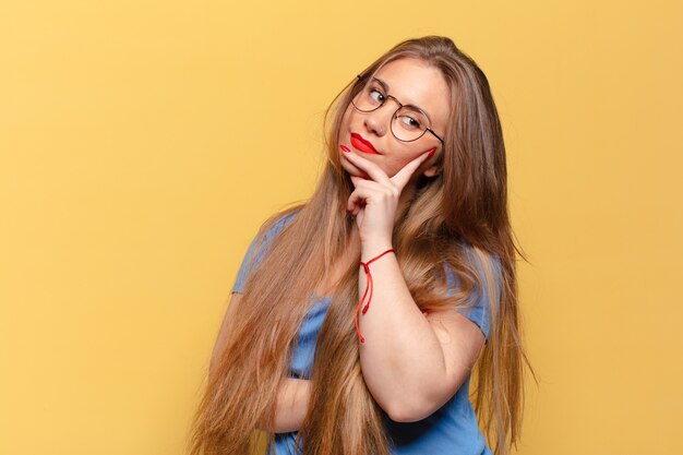 Premium Photo Young Pretty Woman Thinking Or Doubting Expression