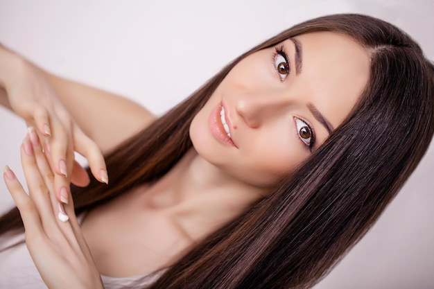 Premium Photo | Young woman applies cream on her hand Premium Photo | Young woman applies cream on her hand