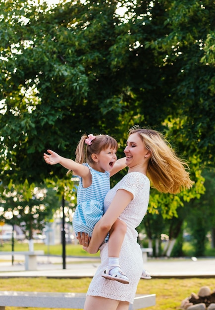 Premium Photo A Young Woman And Her Daughter Are Spinning In Their
