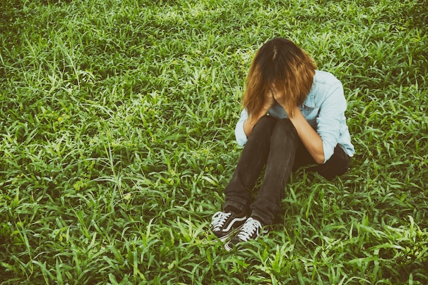Free Photo Young Woman Sitting On The Grass Crying