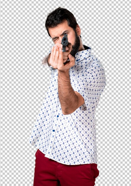 Premium PSD | Handsome brunette man with beard holding a pistol Premium PSD | Handsome brunette man with beard holding a pistol
