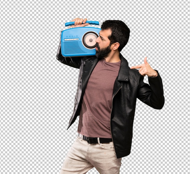 Premium PSD | Handsome man with beard holding a radio Premium PSD | Handsome man with beard holding a radio