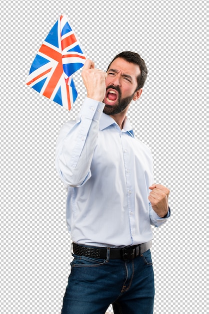Premium PSD | Happy handsome man with beard holding an united kingdom flag Premium PSD | Happy handsome man with beard holding an united kingdom flag