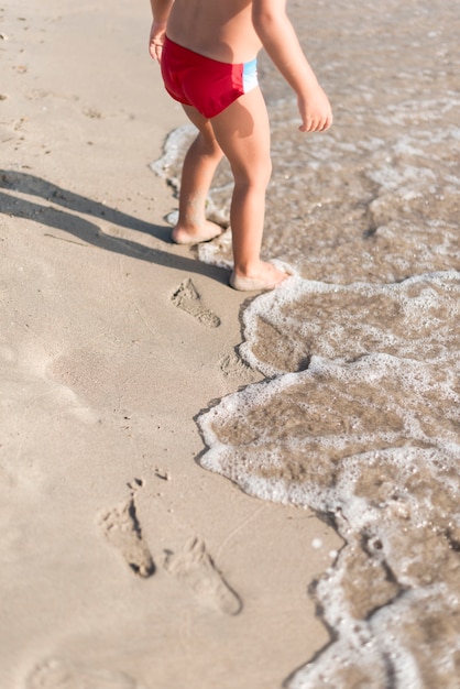 Haute Vue Enfant Jouant Au Bord De La Mer Photo Gratuite